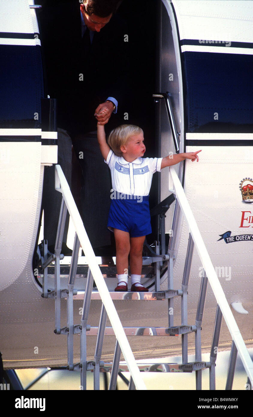 Prince Charles helping a young Prince William down the steps of the ...