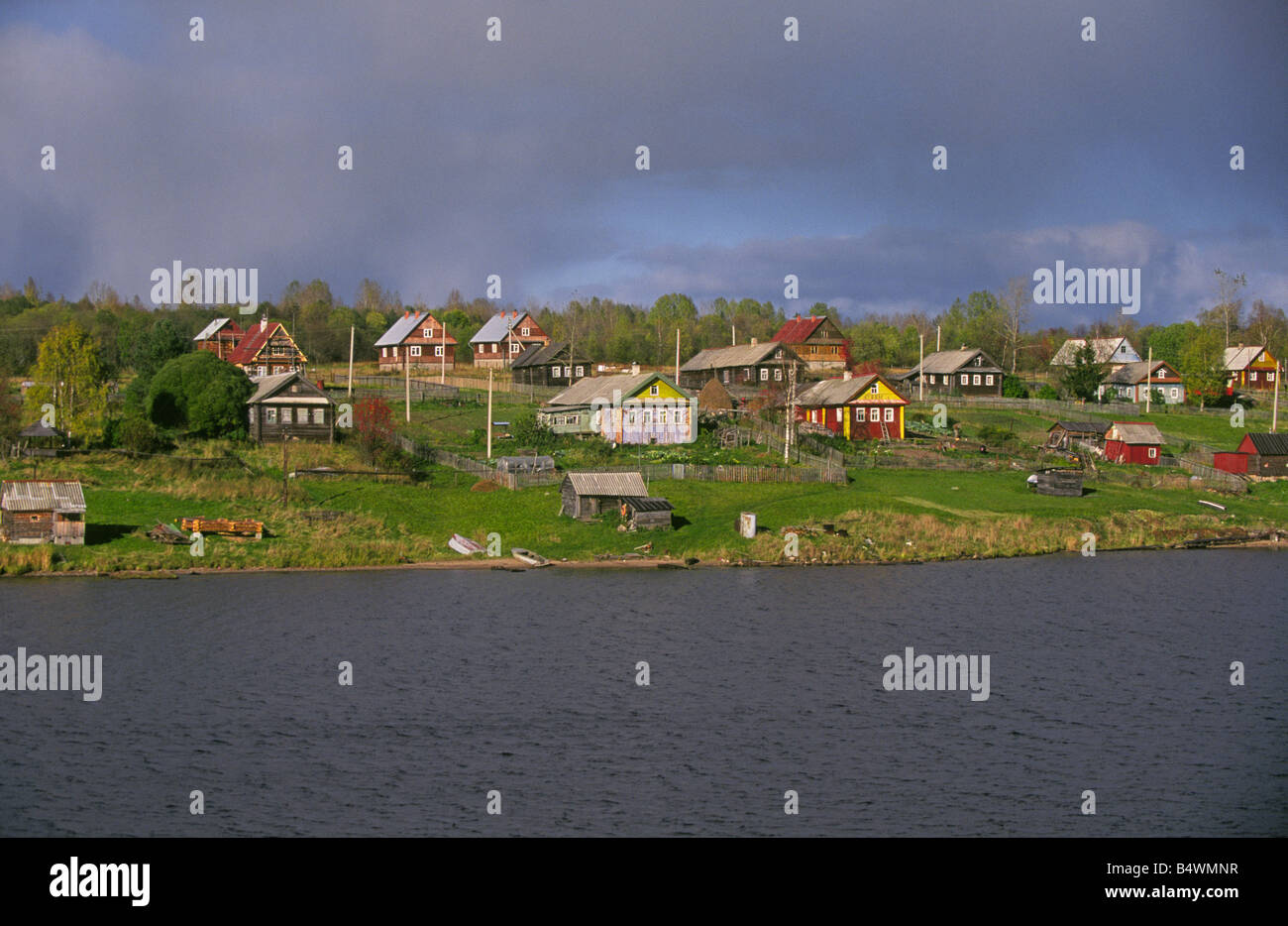 Dachas small farms in a riverside village under a stormy autumn sky ...
