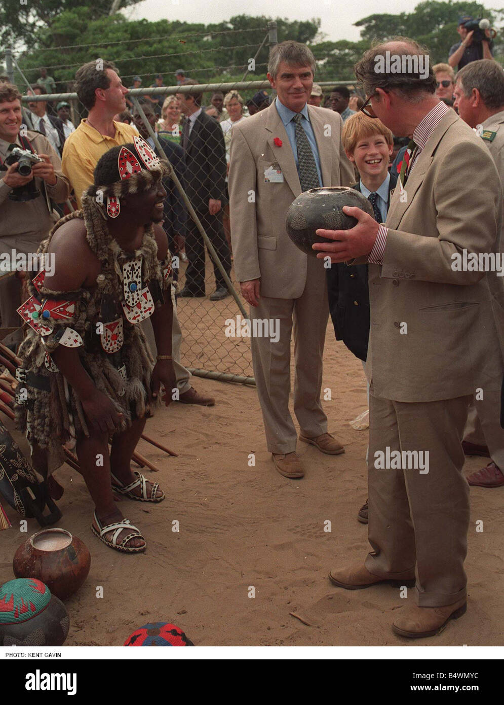 Prince Charles samples the native drink whilst his son Prince Harry ...