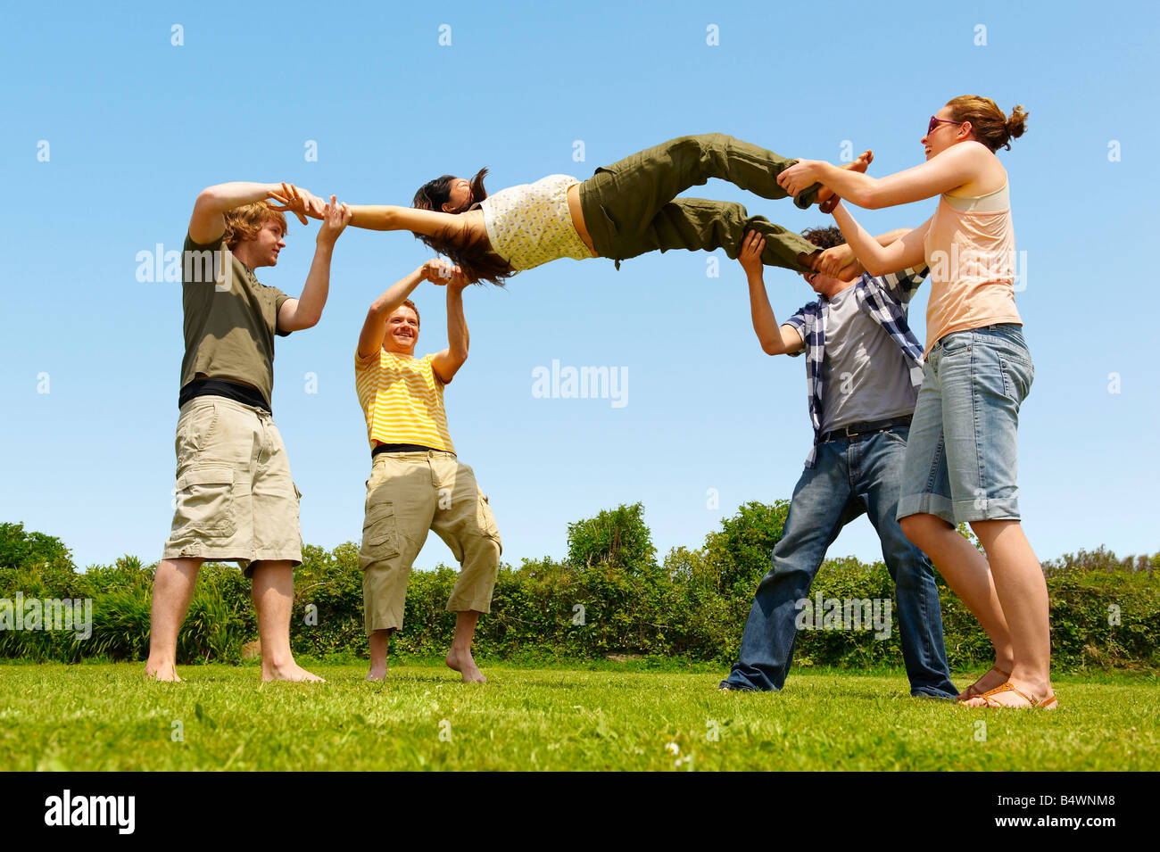 Group young people playing bumps Stock Photo - Alamy