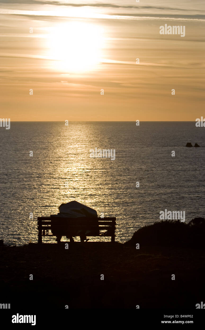 Sunset Jersey couple wrapped up Stock Photo - Alamy