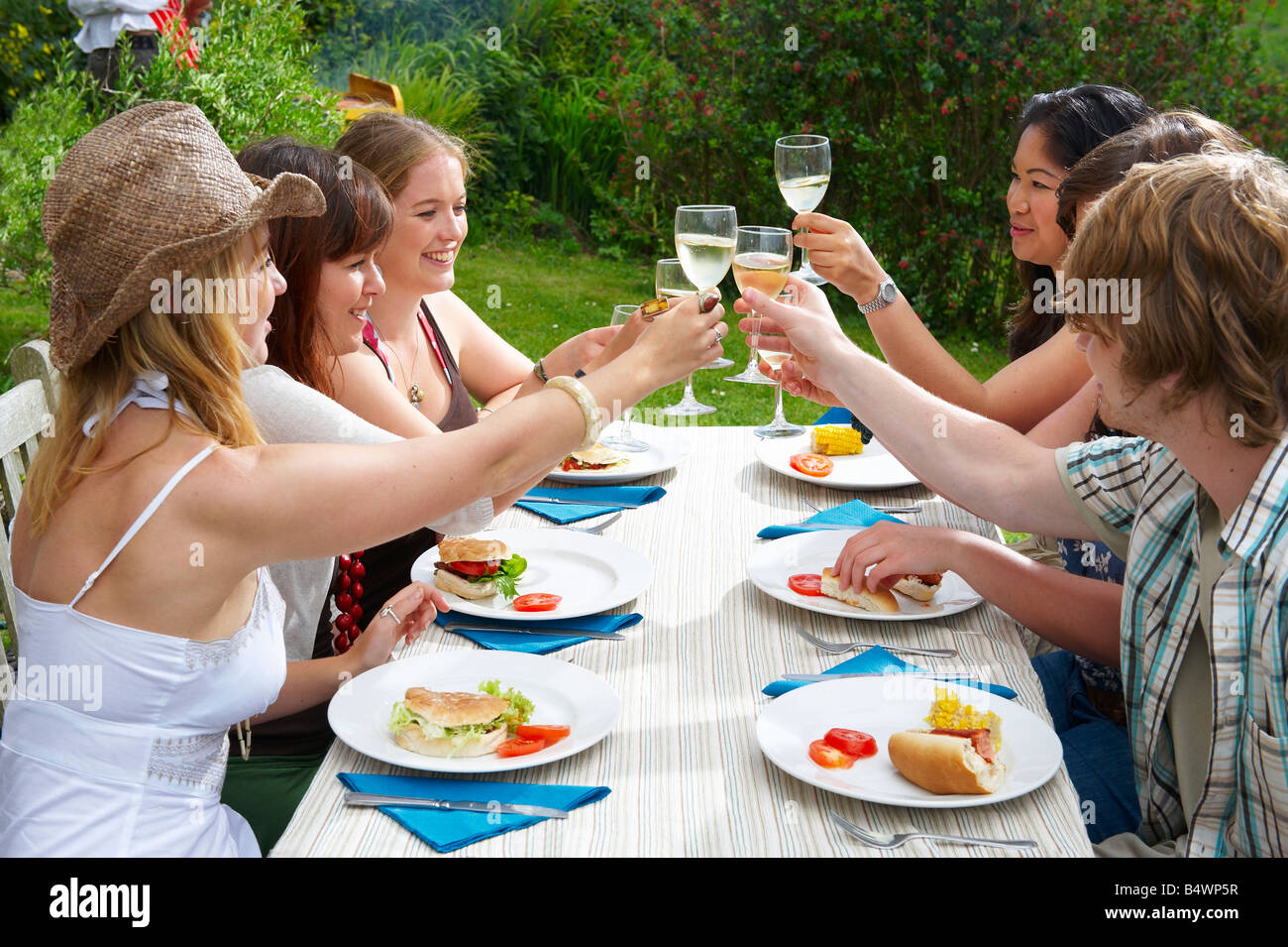 Young people toasting each other Stock Photo - Alamy