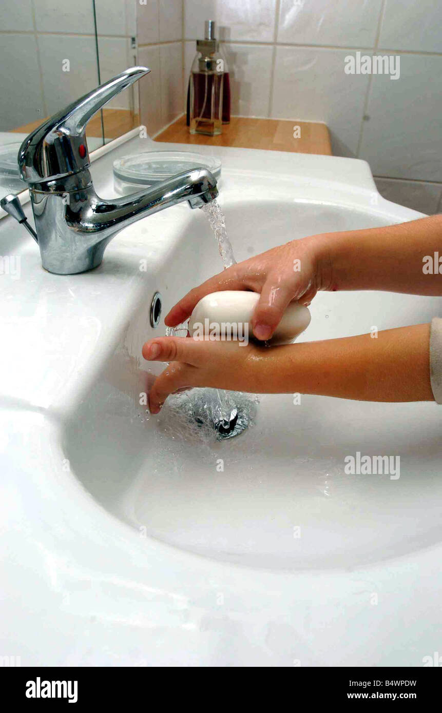 Child washing hands with help hi-res stock photography and images - Alamy