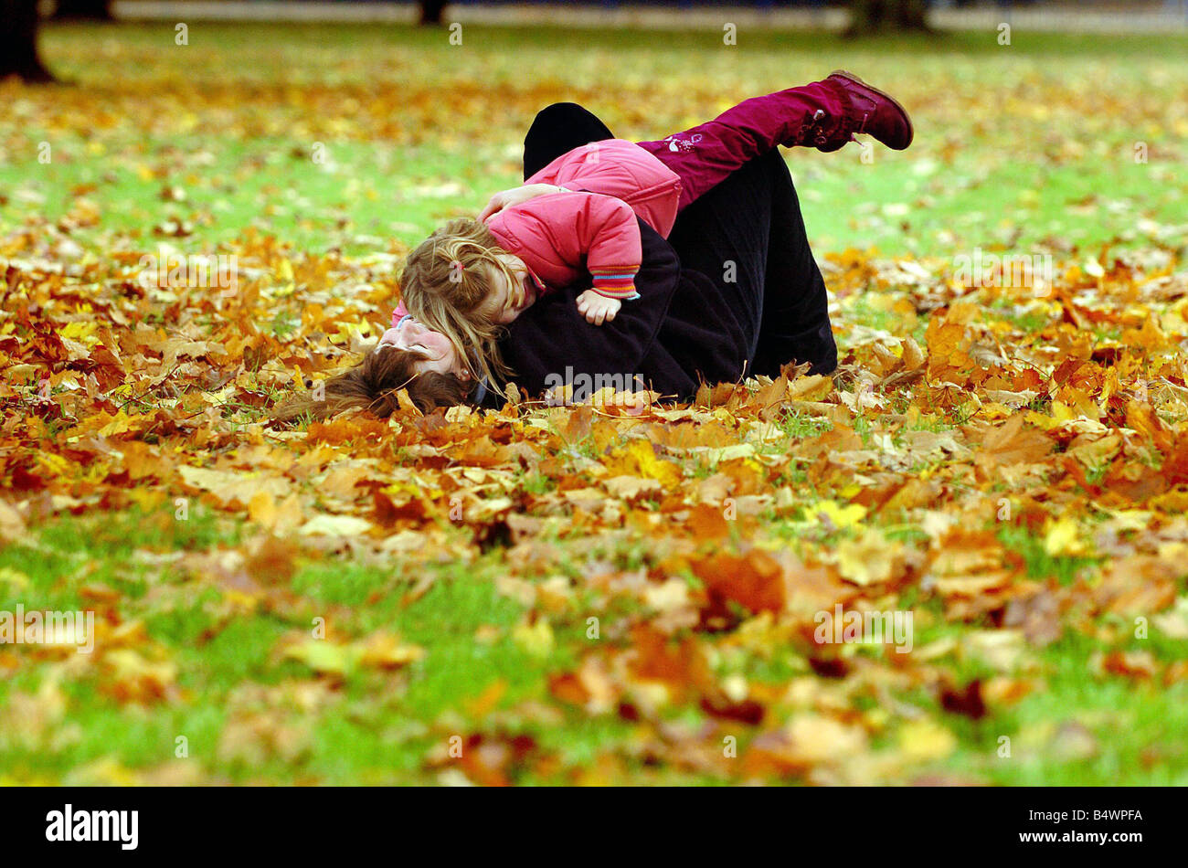 Autumn picture story Eadie Dziemidowicz aged 3 plays with her mother ...