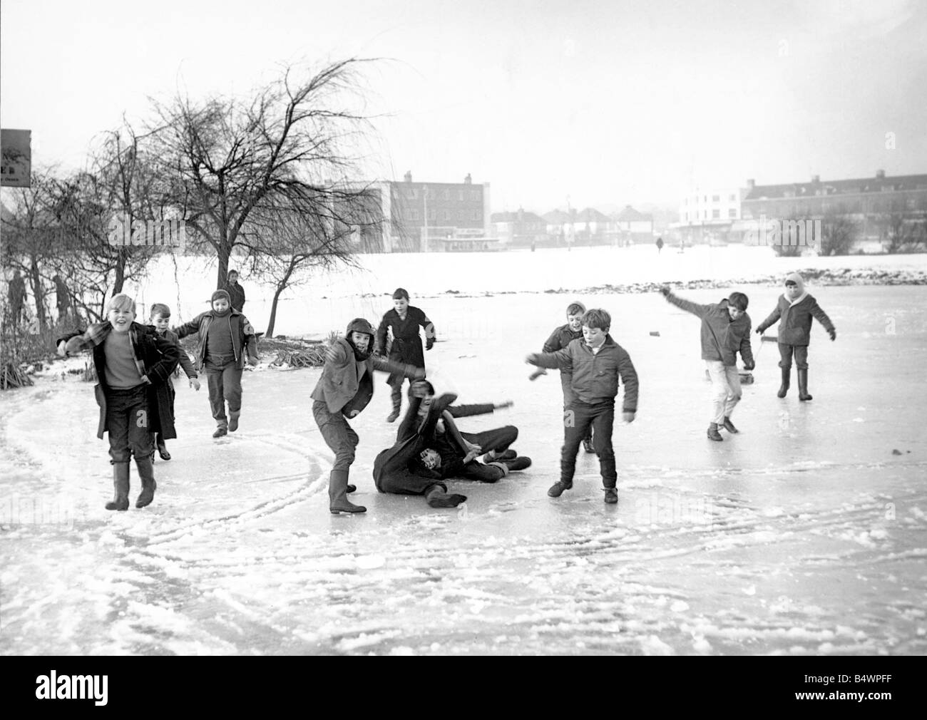 Children play on the ice formed on Quinton Pool, Cheylesmore, Coventry ...