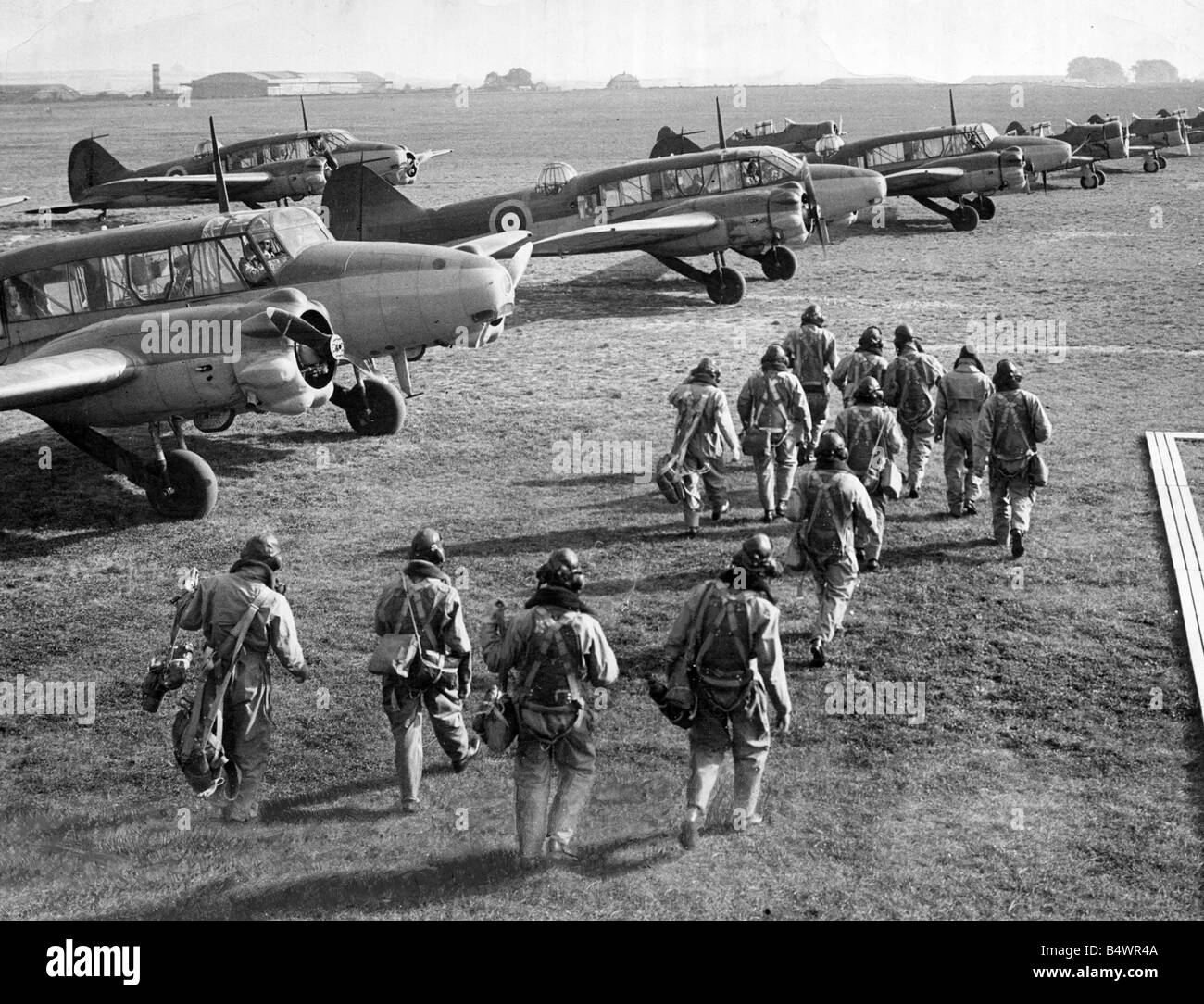 RAF pilots and crew make their way to their Avro Anson planes during ...