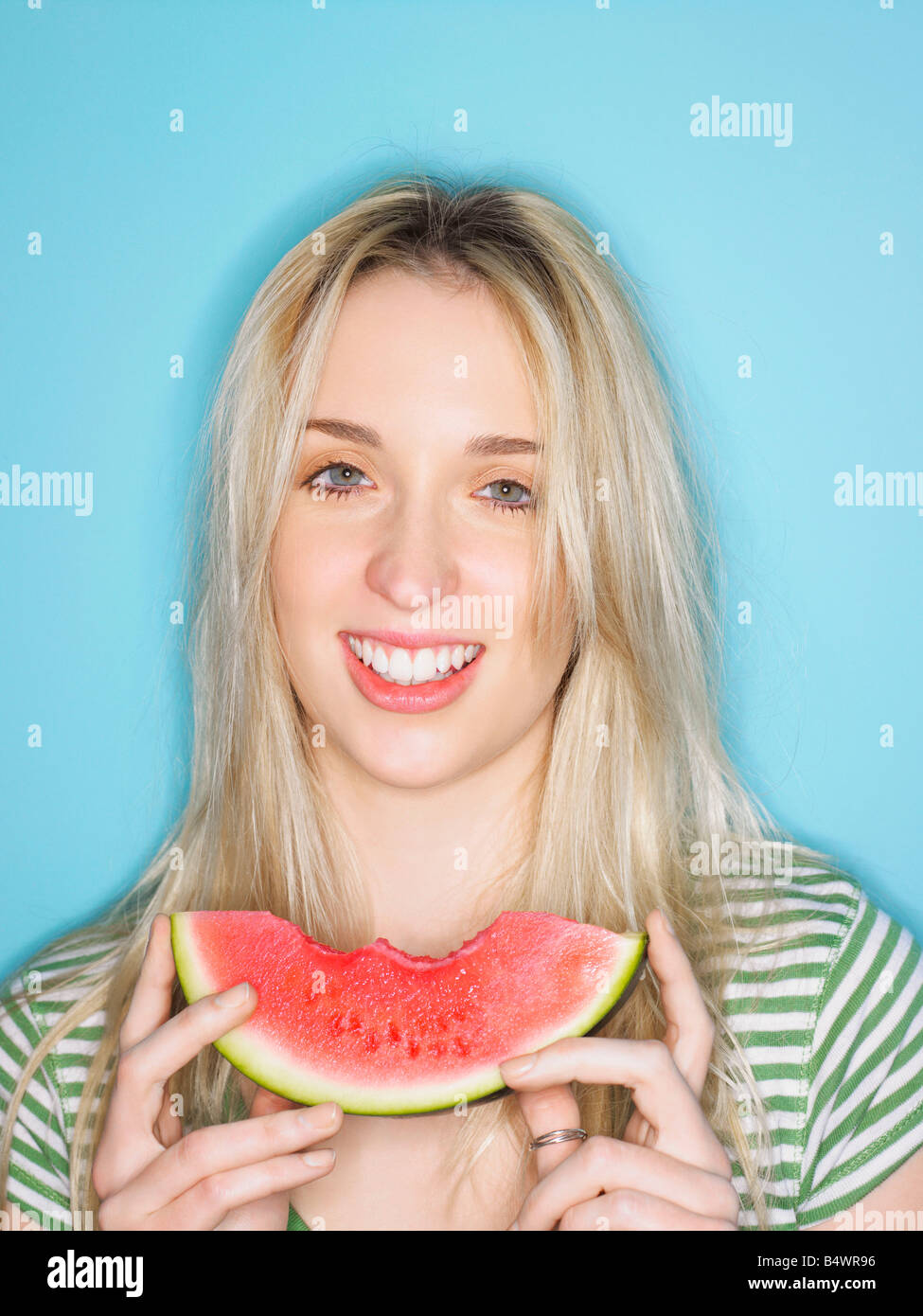 Young woman eating watermelon Stock Photo - Alamy