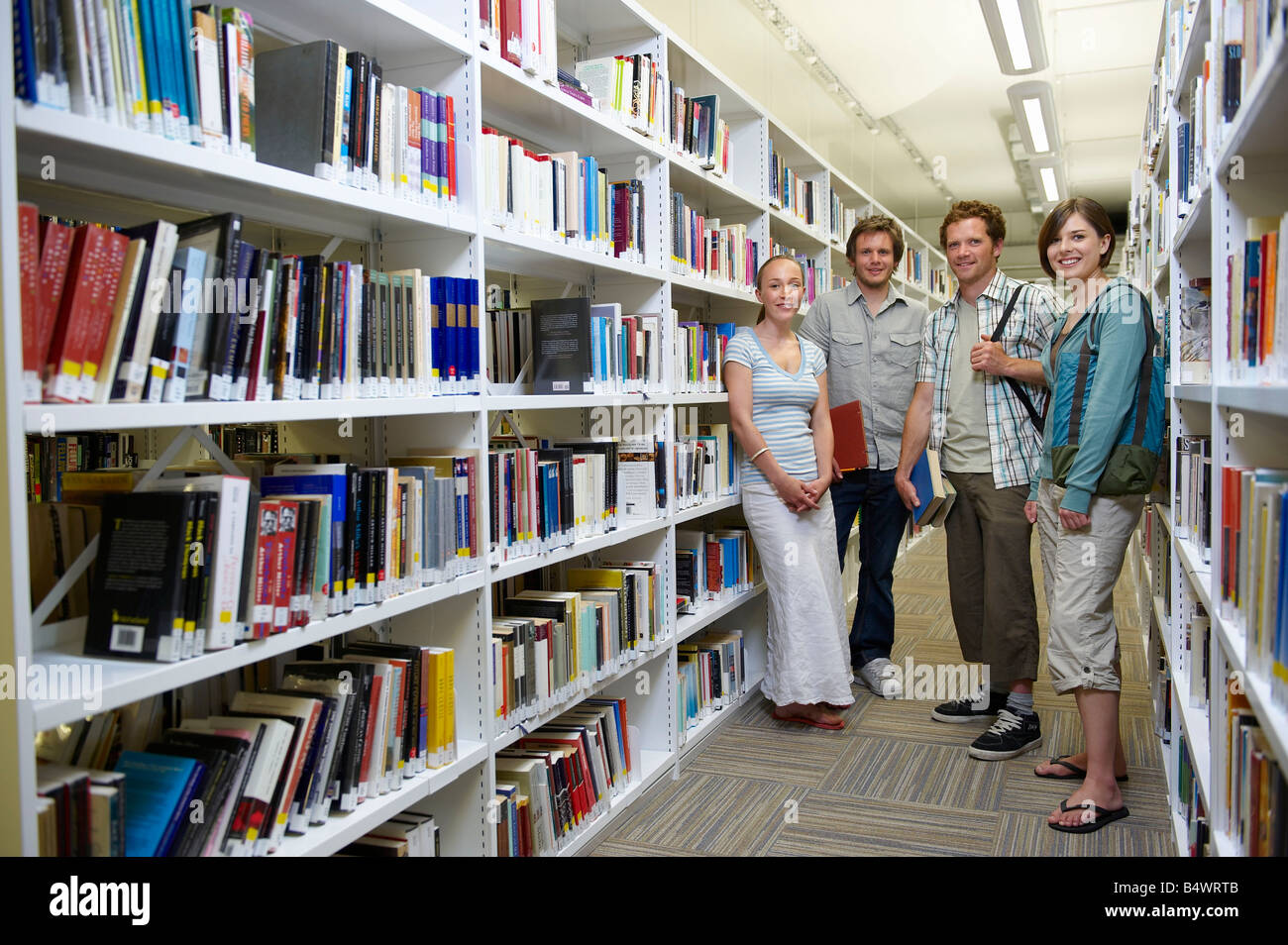 Four people in library standing hi-res stock photography and images - Alamy
