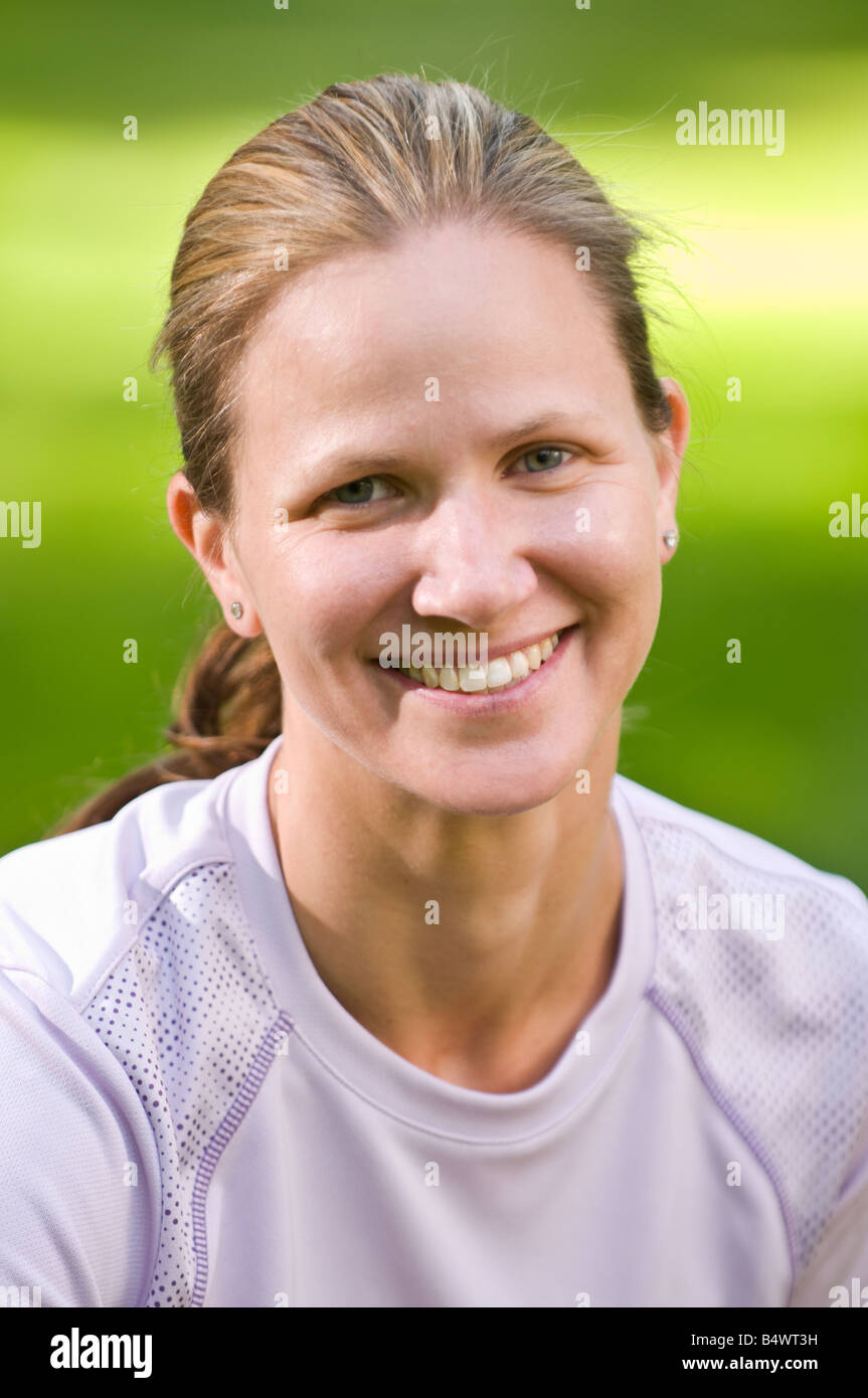 an attractive woman runner smiles for the camera Stock Photo - Alamy