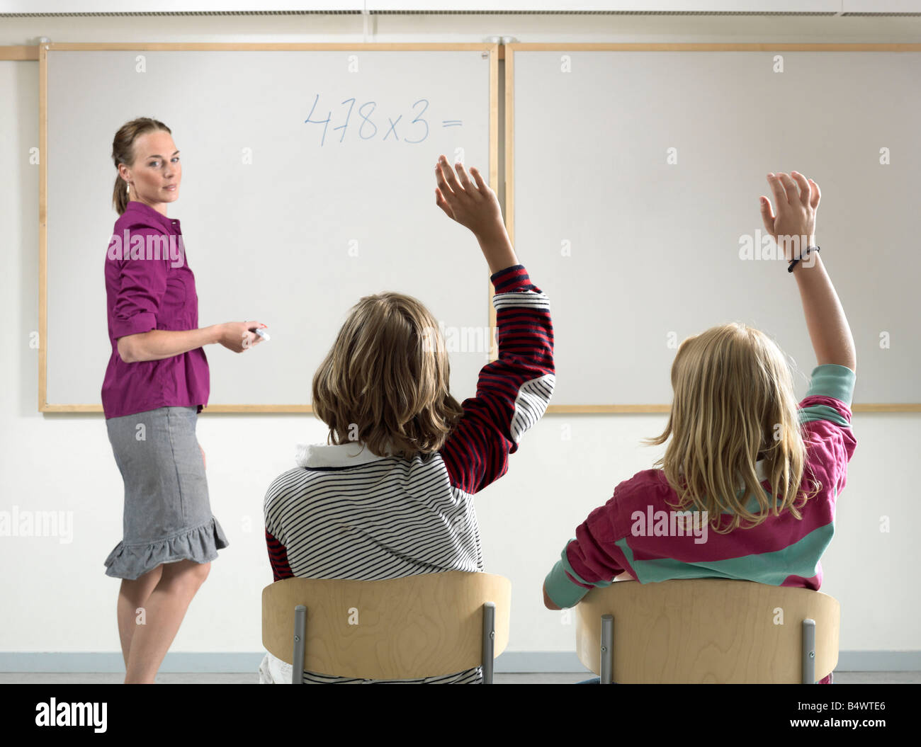 Teacher and two students Stock Photo - Alamy
