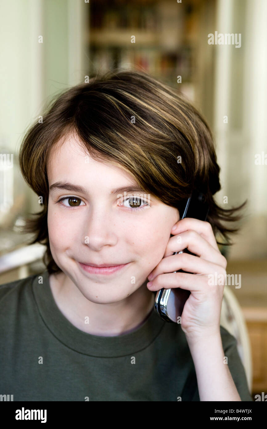 Boy is phoning with his mobile phone Stock Photo - Alamy
