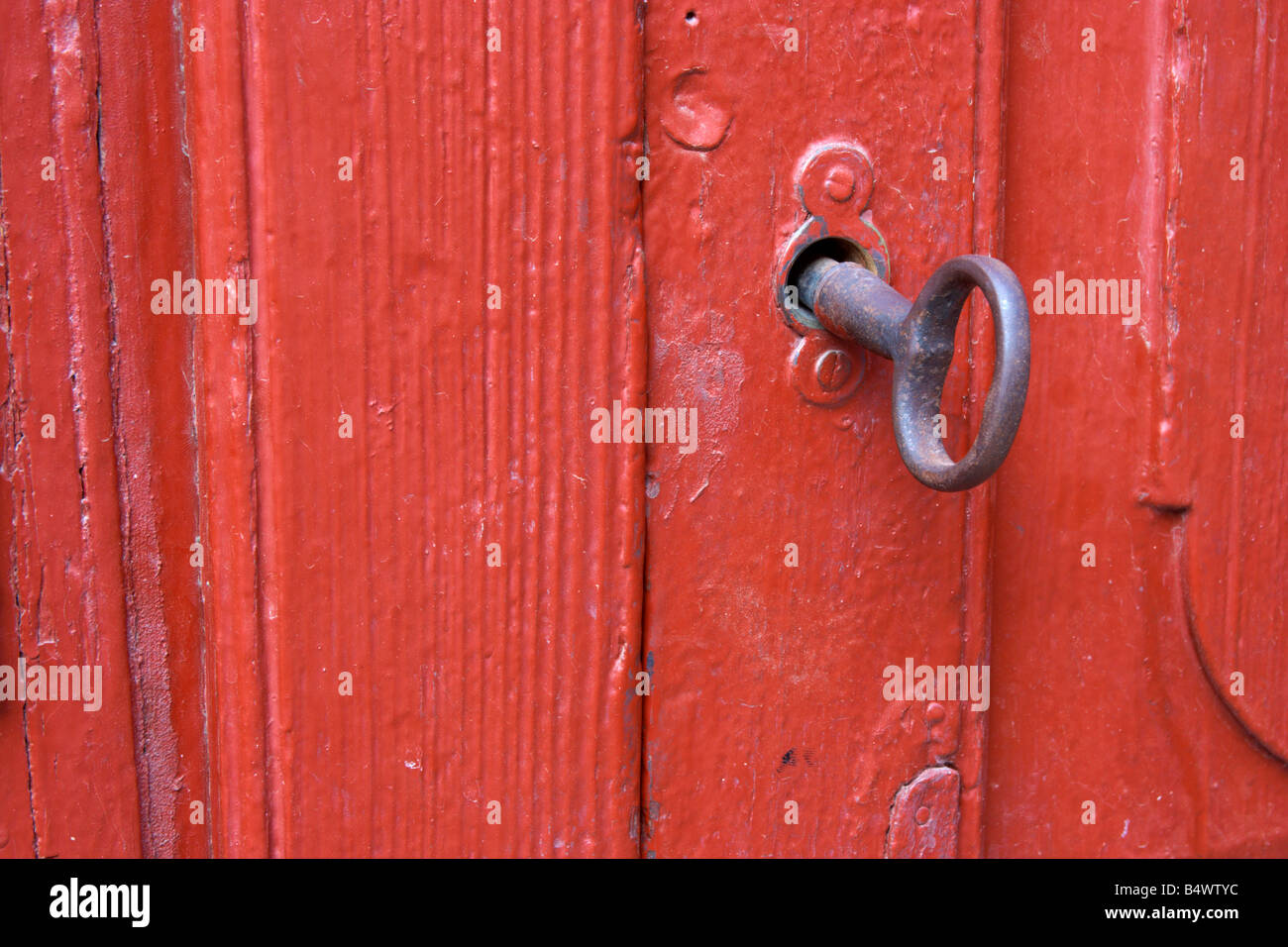 Old key in red wooden door Stock Photo - Alamy