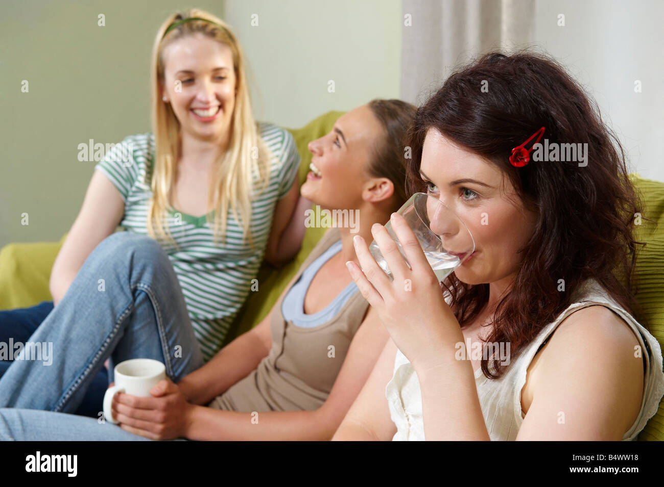 Three young women seated hi-res stock photography and images - Alamy