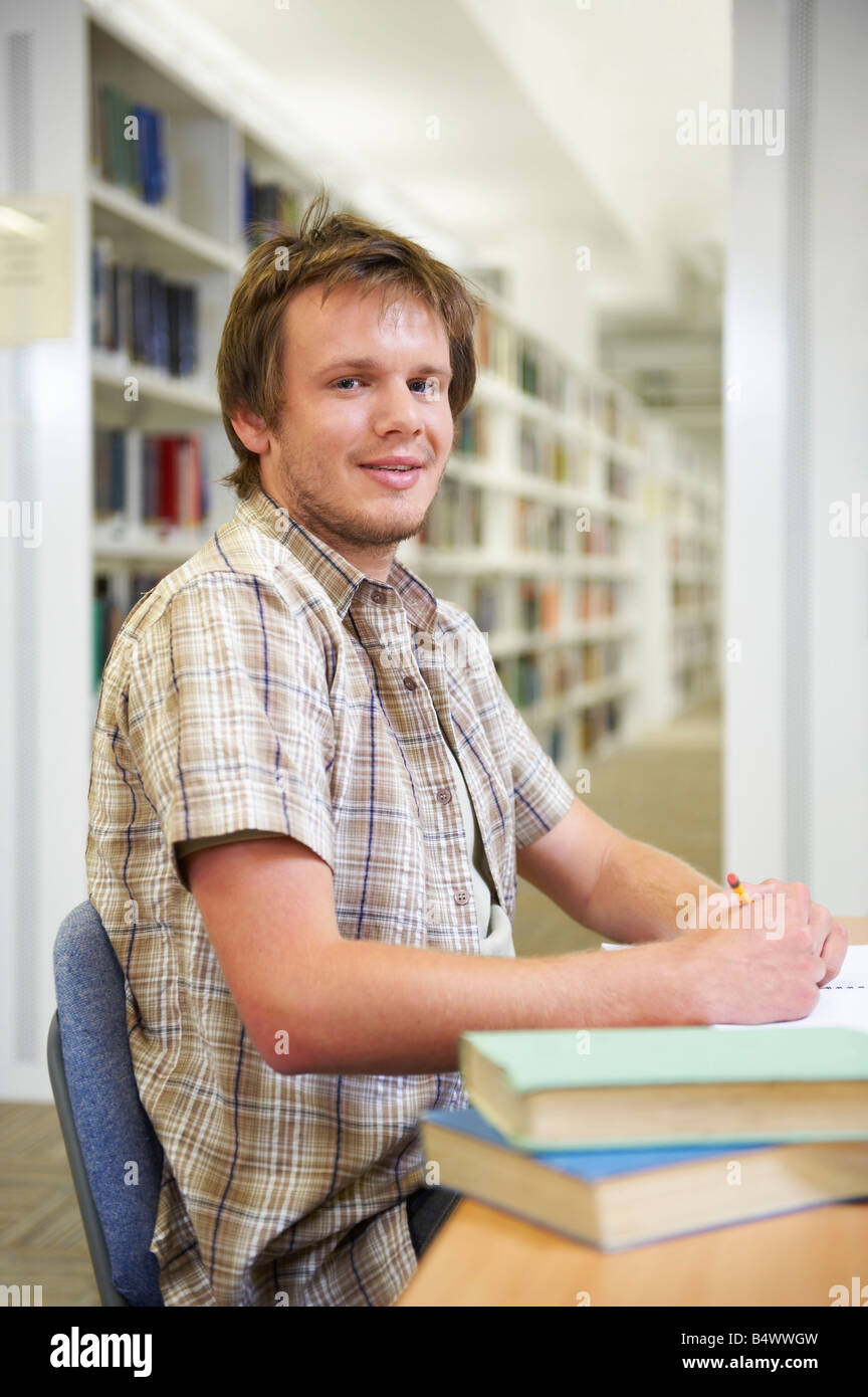 Portrait of young man in library Stock Photo - Alamy