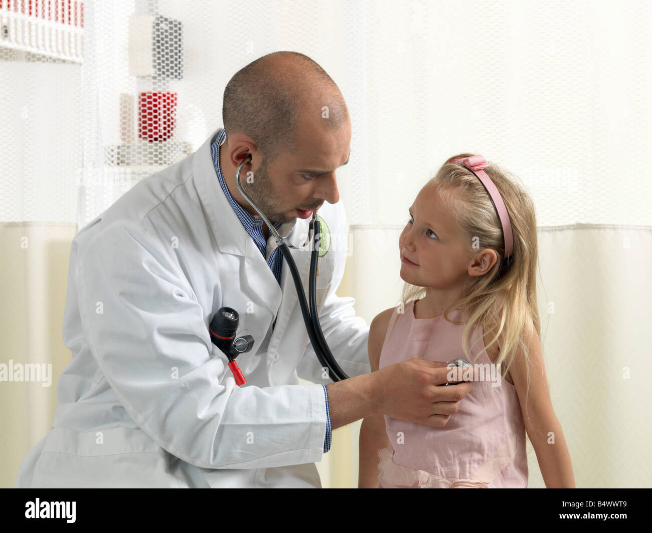 Doctor examining girl Stock Photo - Alamy