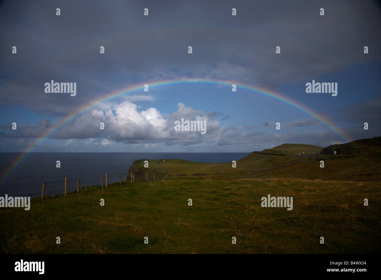 rainbow over cliffs on the north antrim causeway coastal route county ...