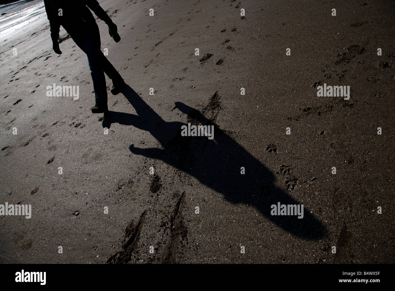 The shadow of a walker on a beach Stock Photo - Alamy