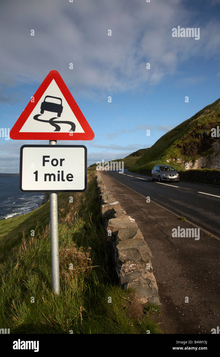 car travelling past the slippery road danger red warning triangle for 1 ...