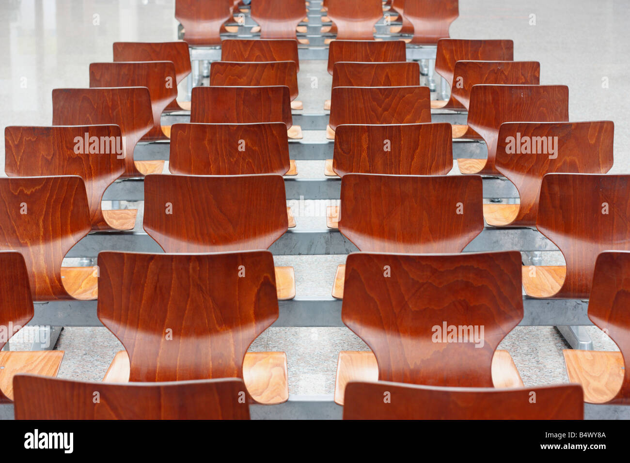 Rows of empty wooden chairs Stock Photo - Alamy