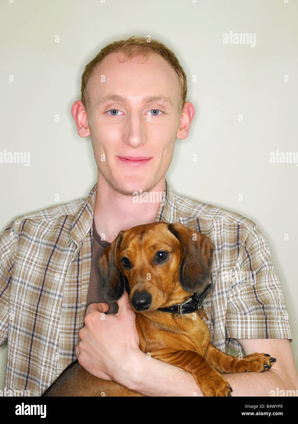 Portrait of young man with dog Stock Photo - Alamy