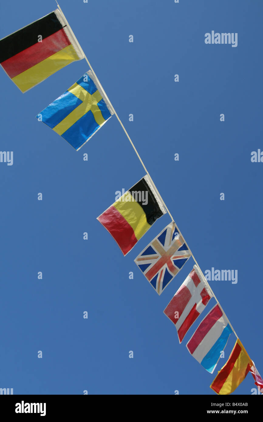 old faded international flags flying in wind in sun Stock Photo - Alamy