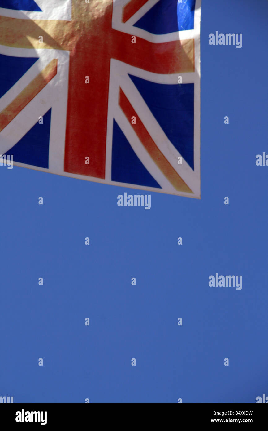 old faded union jack flag flying in wind in sun Stock Photo - Alamy