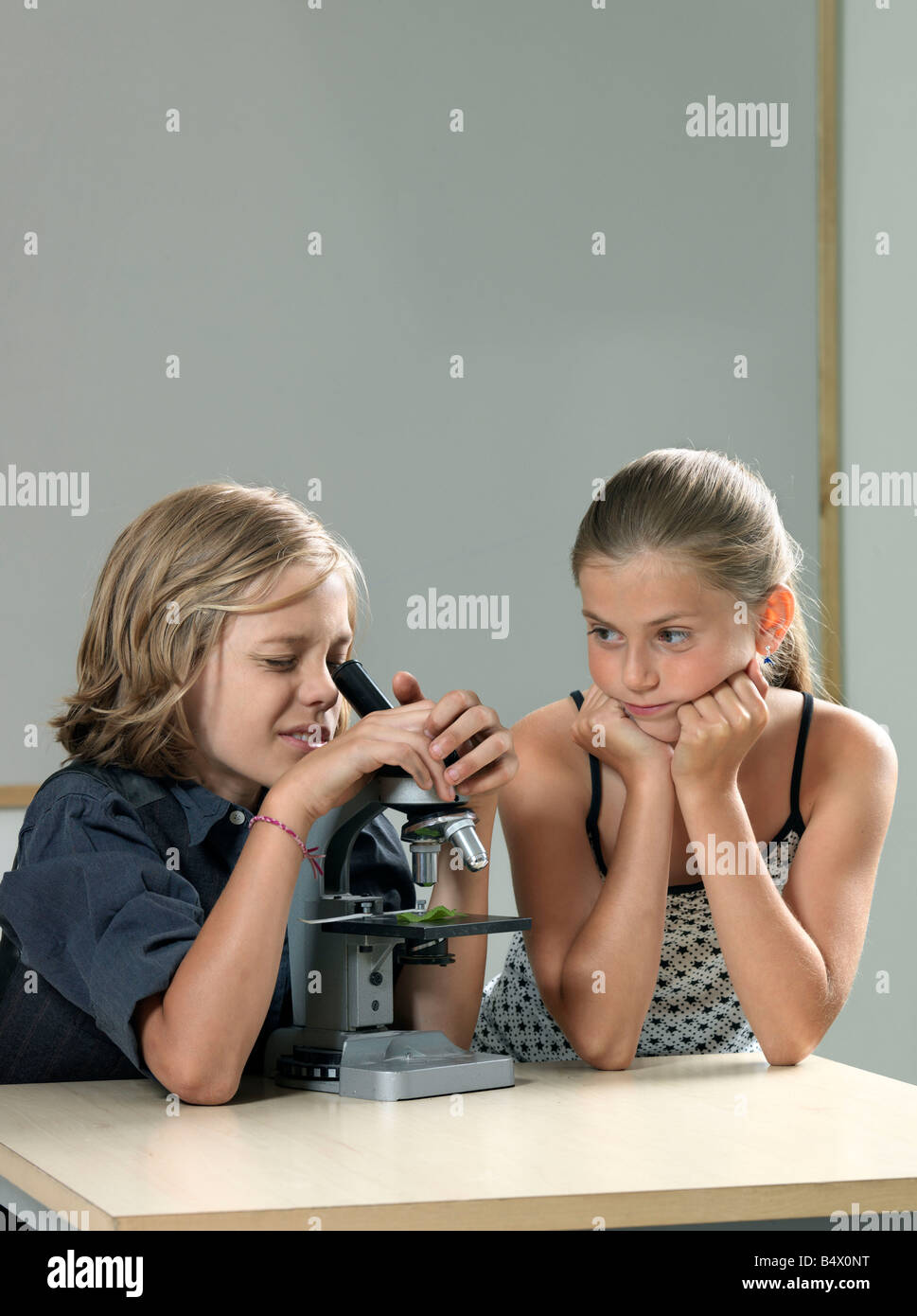 Two kids using microscope Stock Photo - Alamy