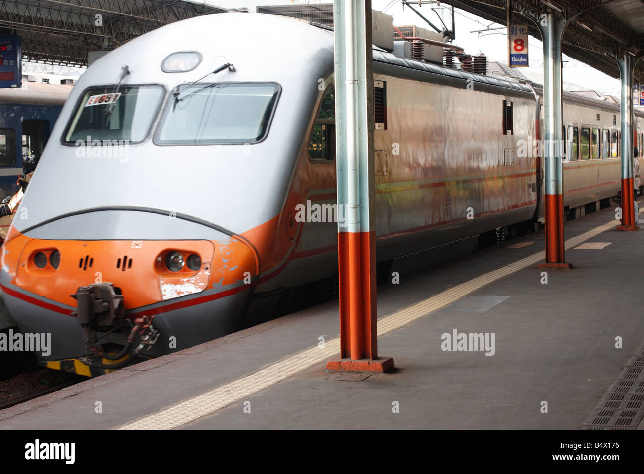 Train arriving at a train station platform Stock Photo - Alamy