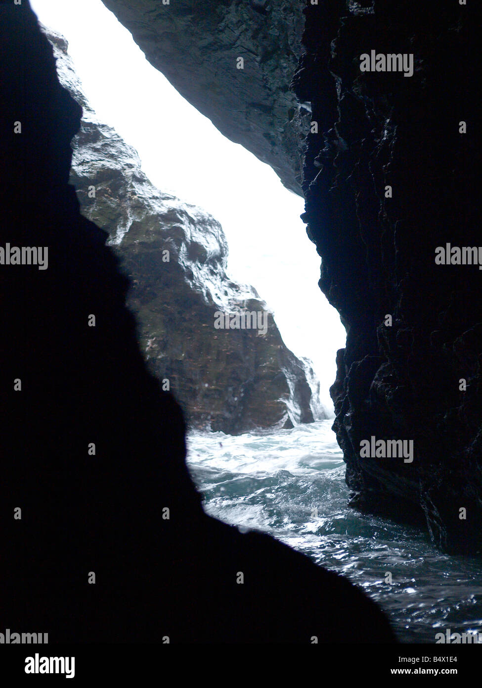 Inside a cave, looking out at the ocean Stock Photo - Alamy