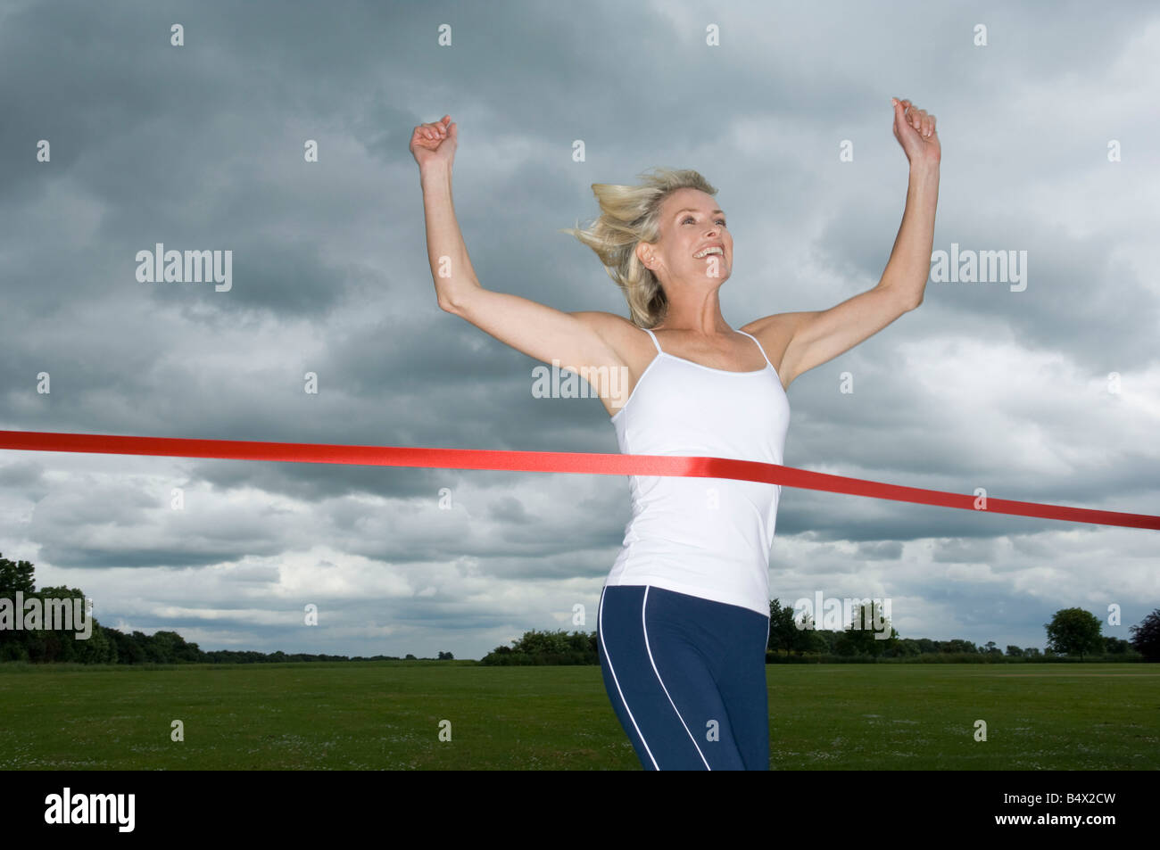 Healthy woman winning running race Stock Photo - Alamy