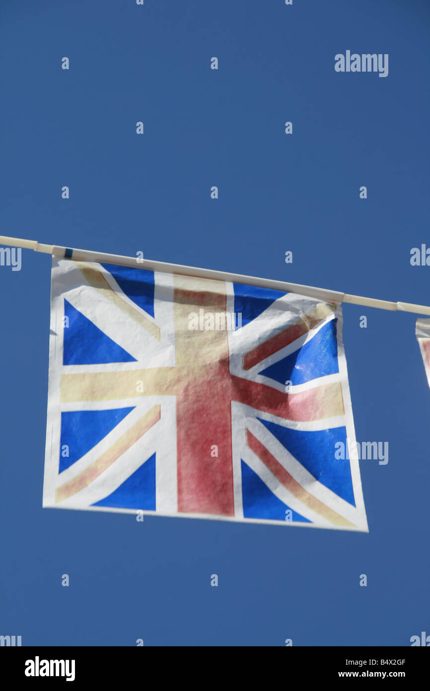 old faded union jack flag flying in wind in sun Stock Photo - Alamy