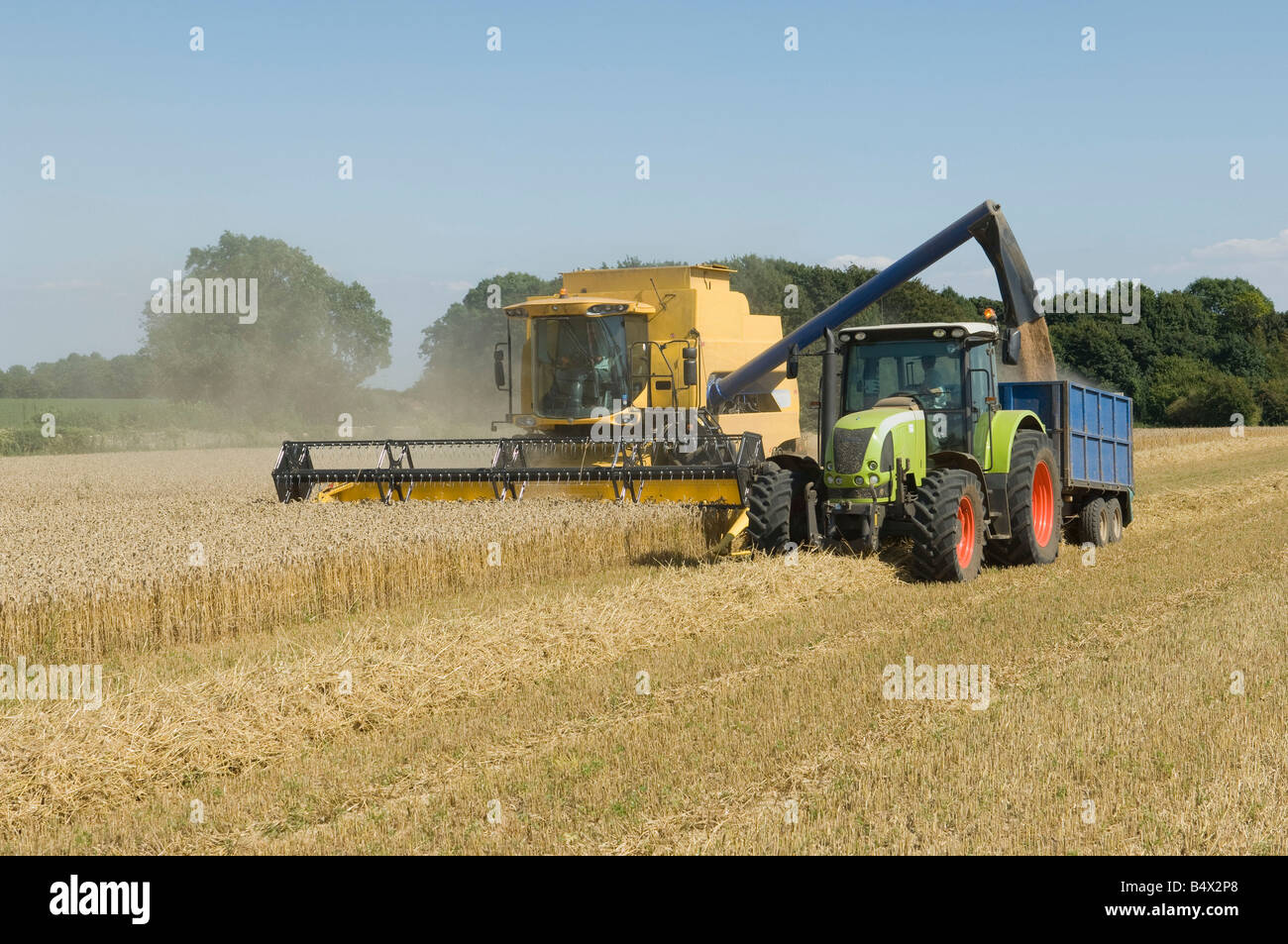 Combine harvester with tractor Stock Photo - Alamy