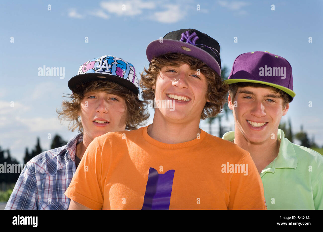 Teen triplet boys smiling portrait Stock Photo - Alamy