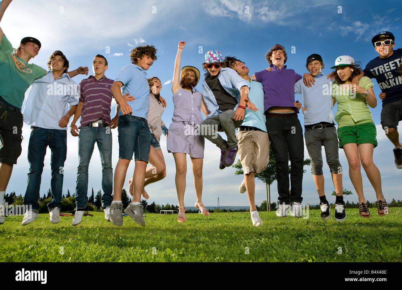 Teen group jumping in park Stock Photo - Alamy