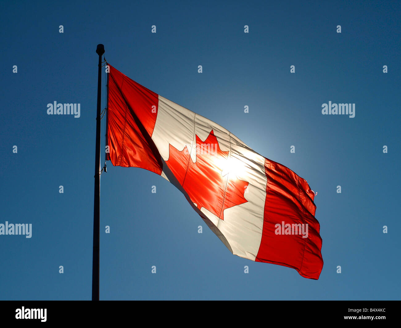 Canadian flag with the sun behind it Stock Photo - Alamy