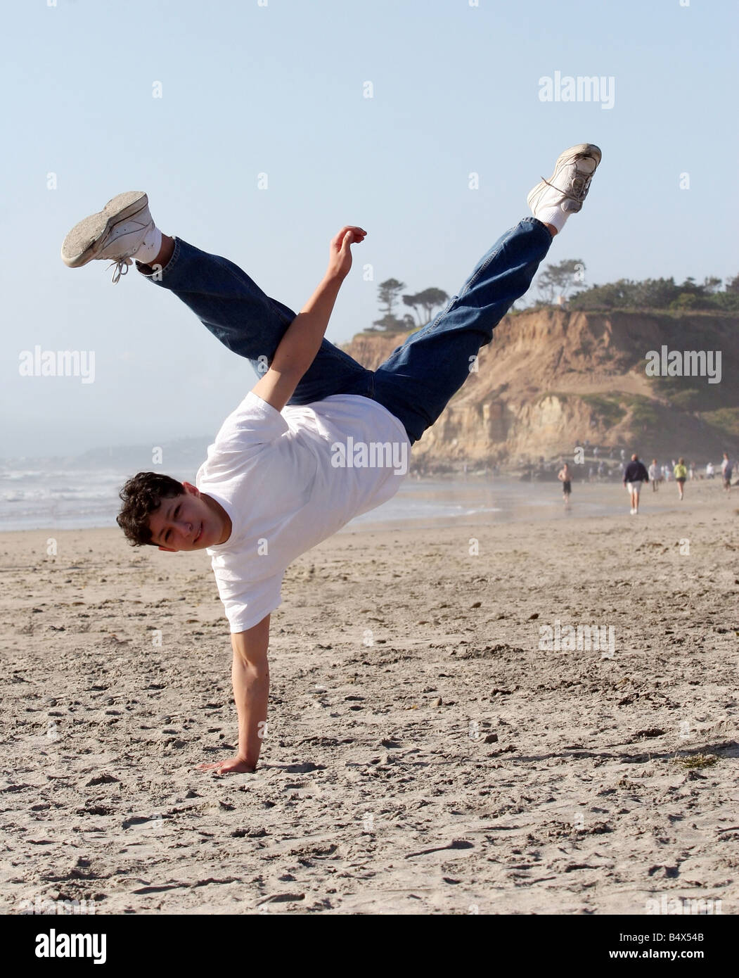 Boy standing on one hand Stock Photo - Alamy