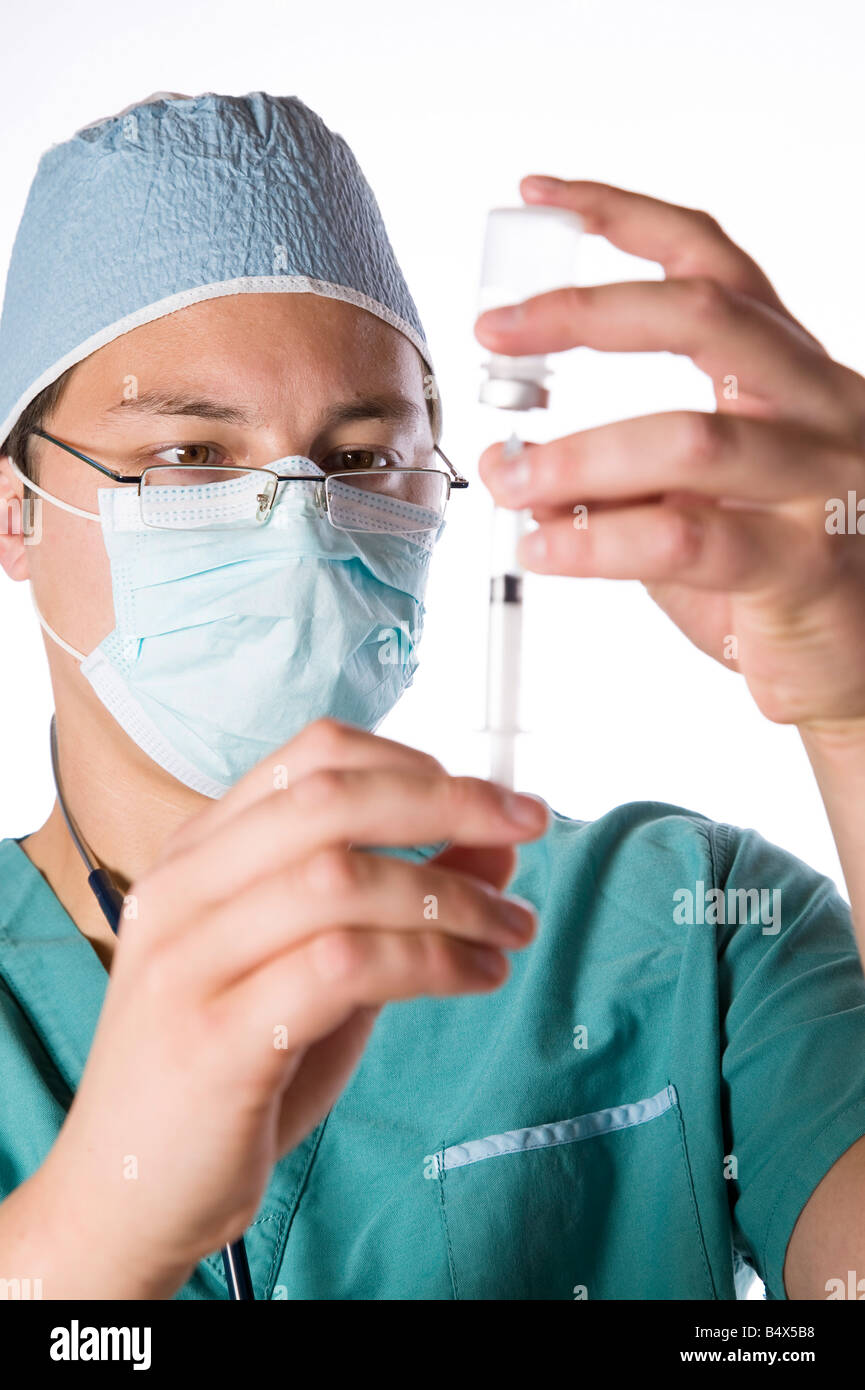 Doctor preparing a syringe isolated against white background Stock ...