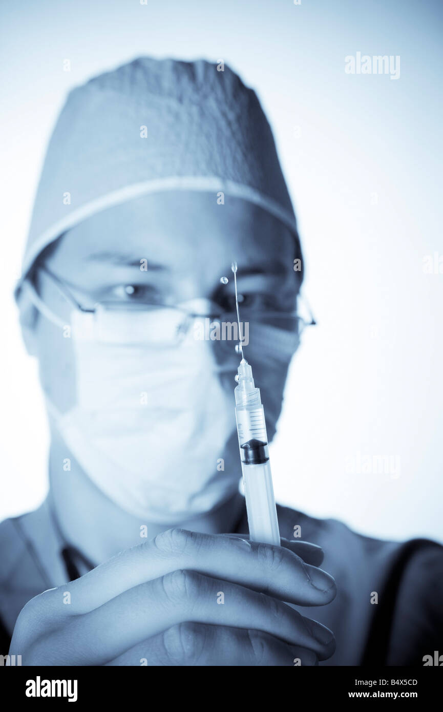 Doctor preparing a syringe isolated against white background Stock ...