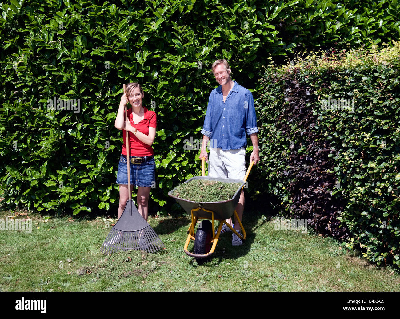 Portrait of couple with garden tools Stock Photo - Alamy
