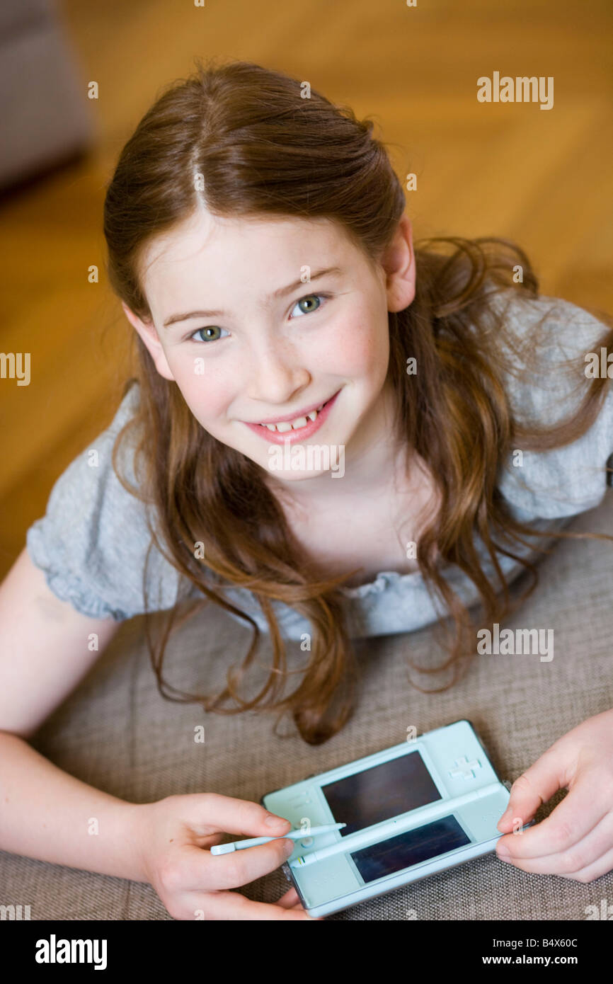 Girl playing video games, looking up Stock Photo - Alamy