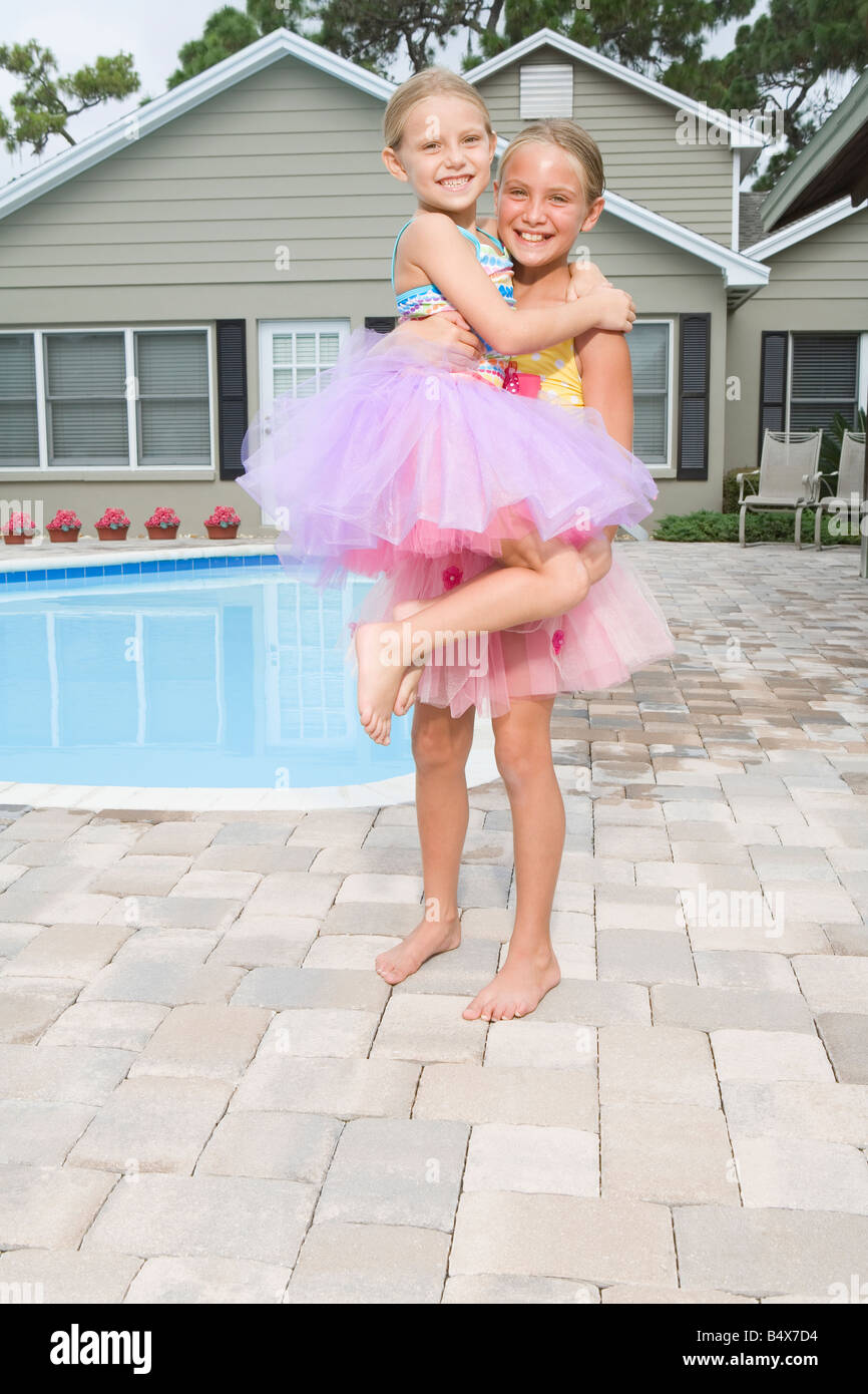 Girls in tutus playing by swimming pool Stock Photo - Alamy