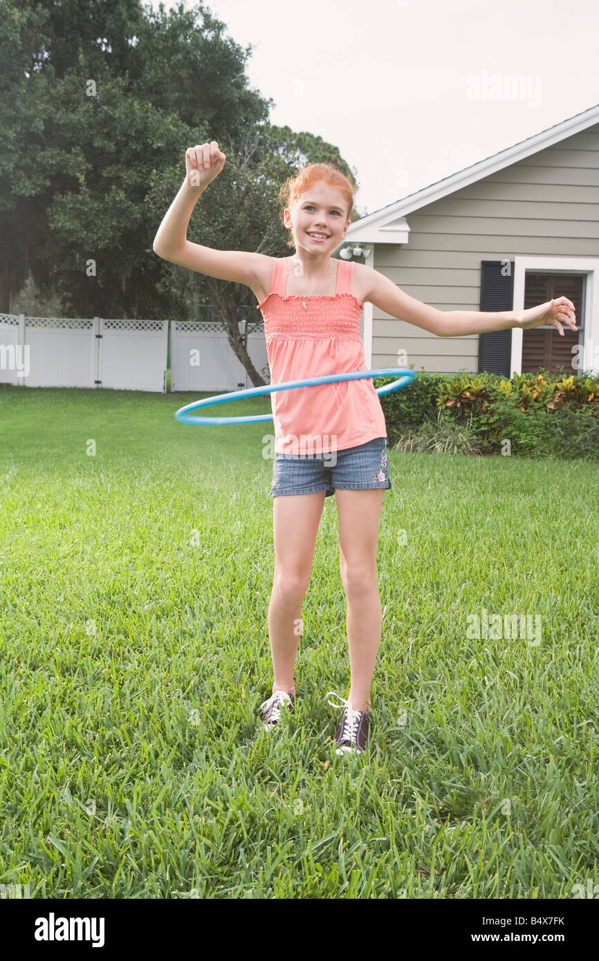 Girl hula hooping in backyard Stock Photo - Alamy
