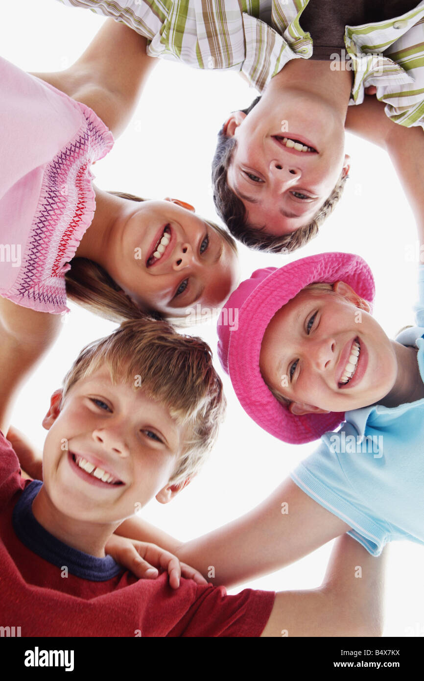 Low angle view of children in a huddle Stock Photo - Alamy