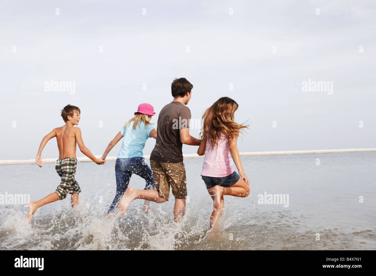 Children running in ocean Stock Photo - Alamy