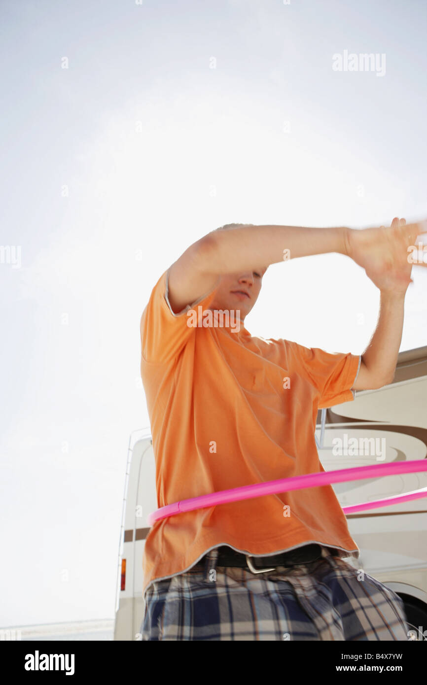 Young man spinning hula hoop hi-res stock photography and images - Alamy