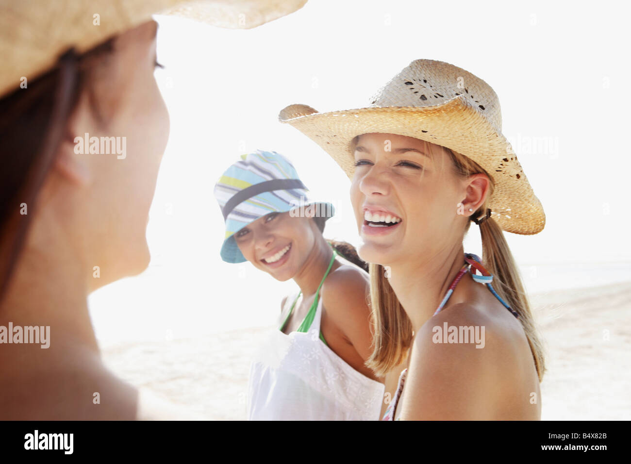 Friends laughing in beach Stock Photo - Alamy