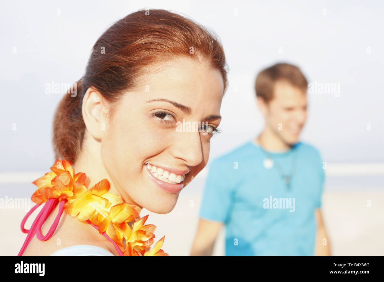 Young woman smiling on beach Stock Photo - Alamy