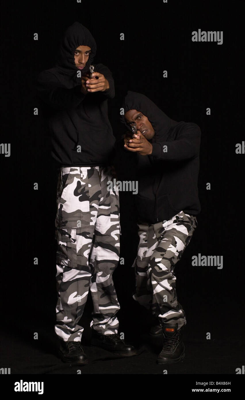 Models pose as Yardie Gangsters wearing black top with hoods camouflage ...