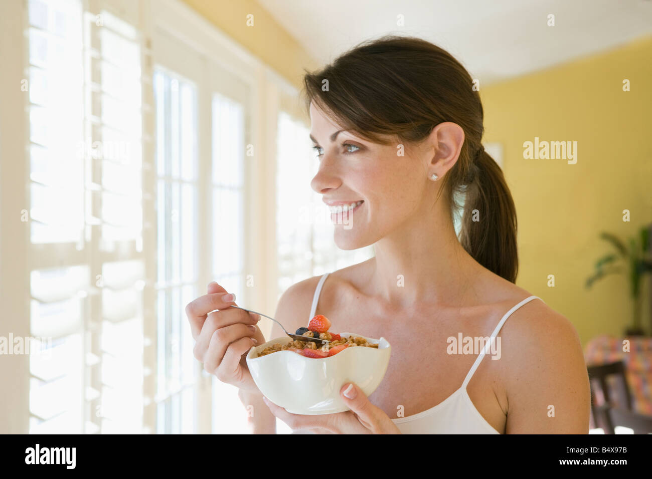Woman eating breakfast Stock Photo - Alamy