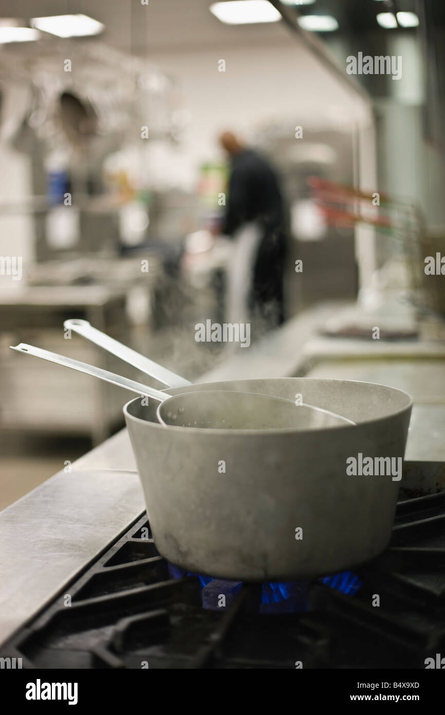 Steaming pots on gas stove Stock Photo - Alamy